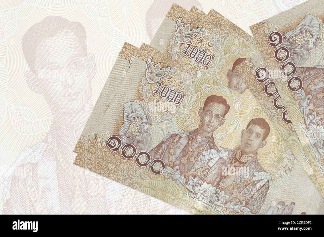 1000 Thai baht bills lies in stack on background of big semi ...