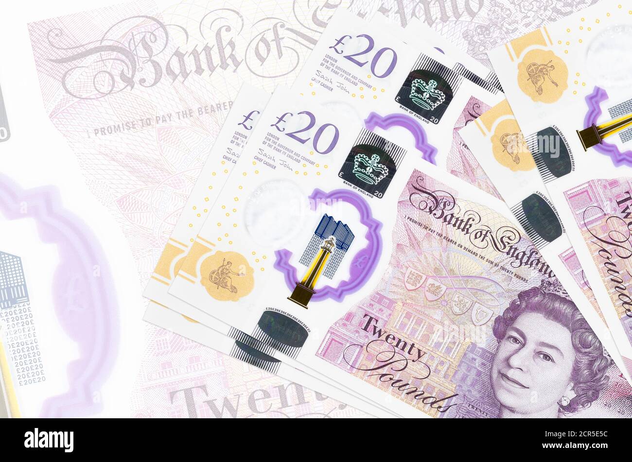 20 British pounds bills lies in stack on background of big semi ...