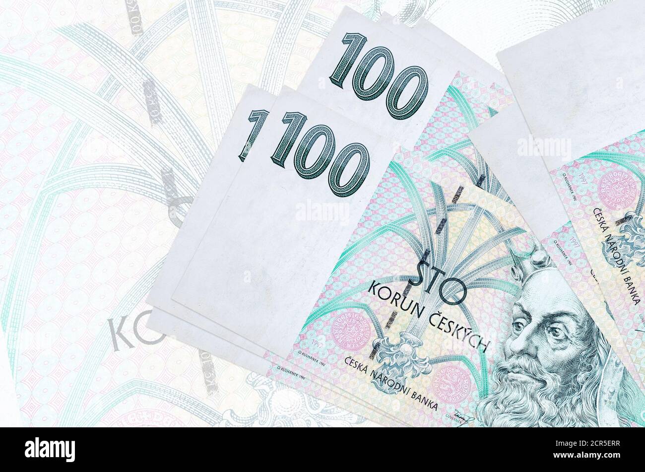 100 Czech korun bills lies in stack on background of big semi ...