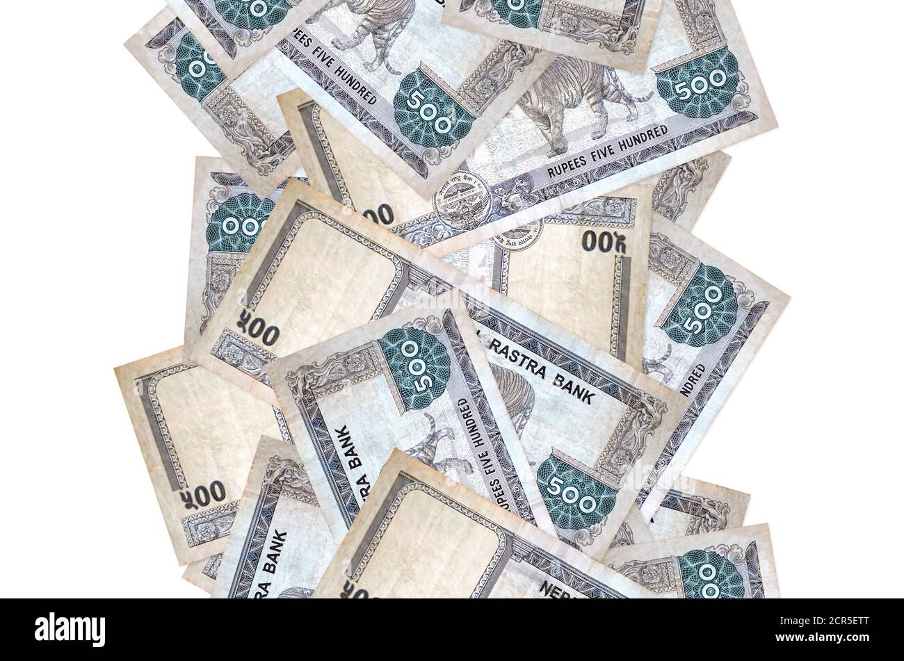 500 Nepalese rupees bills flying down isolated on white. Many banknotes ...