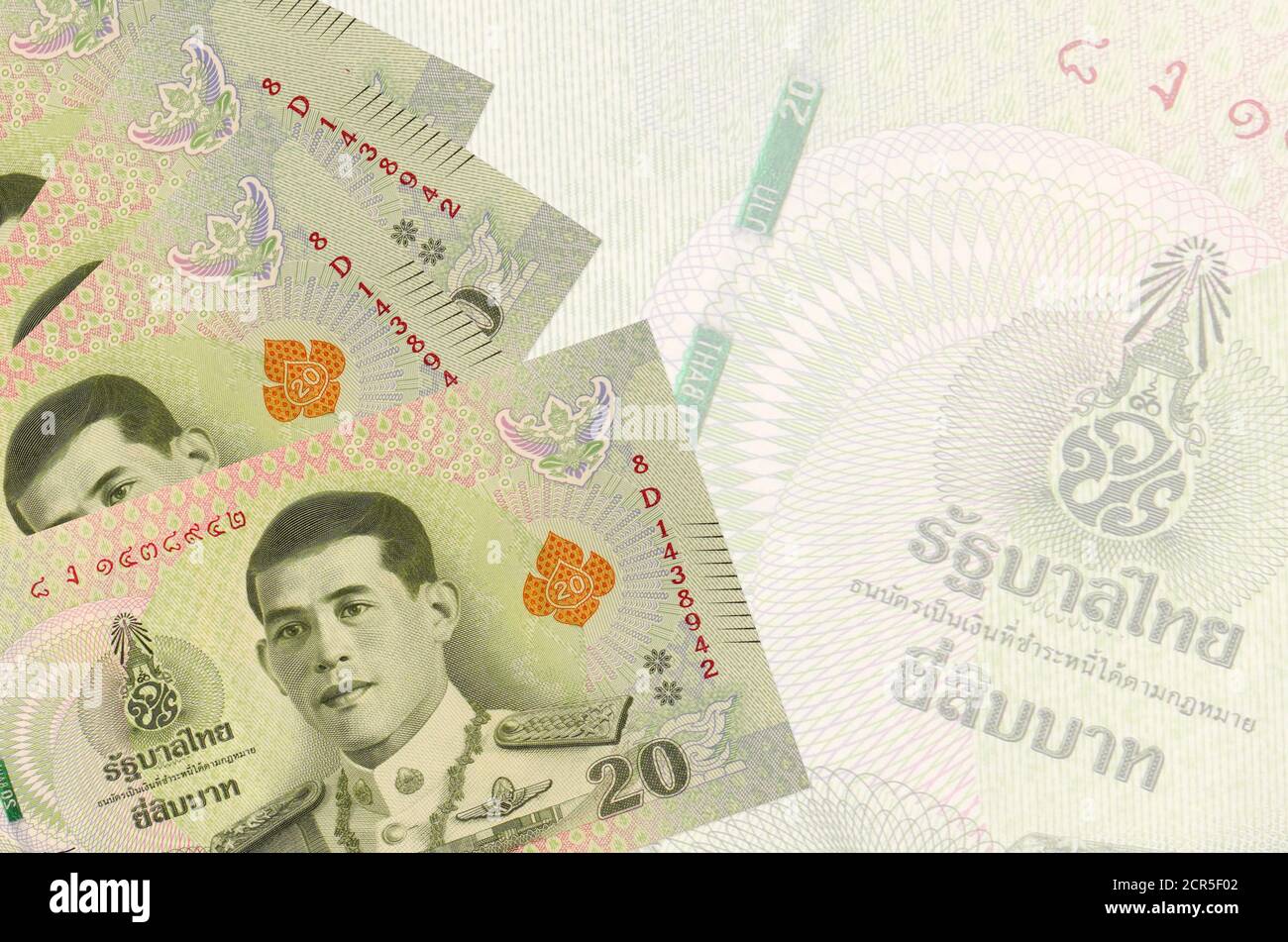 20 Thai Baht bills lies in stack on background of big semi-transparent ...