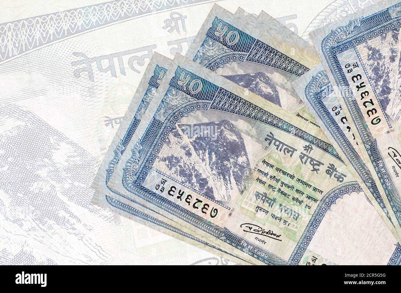 50 Nepalese rupees bills lies in stack on background of big semi ...