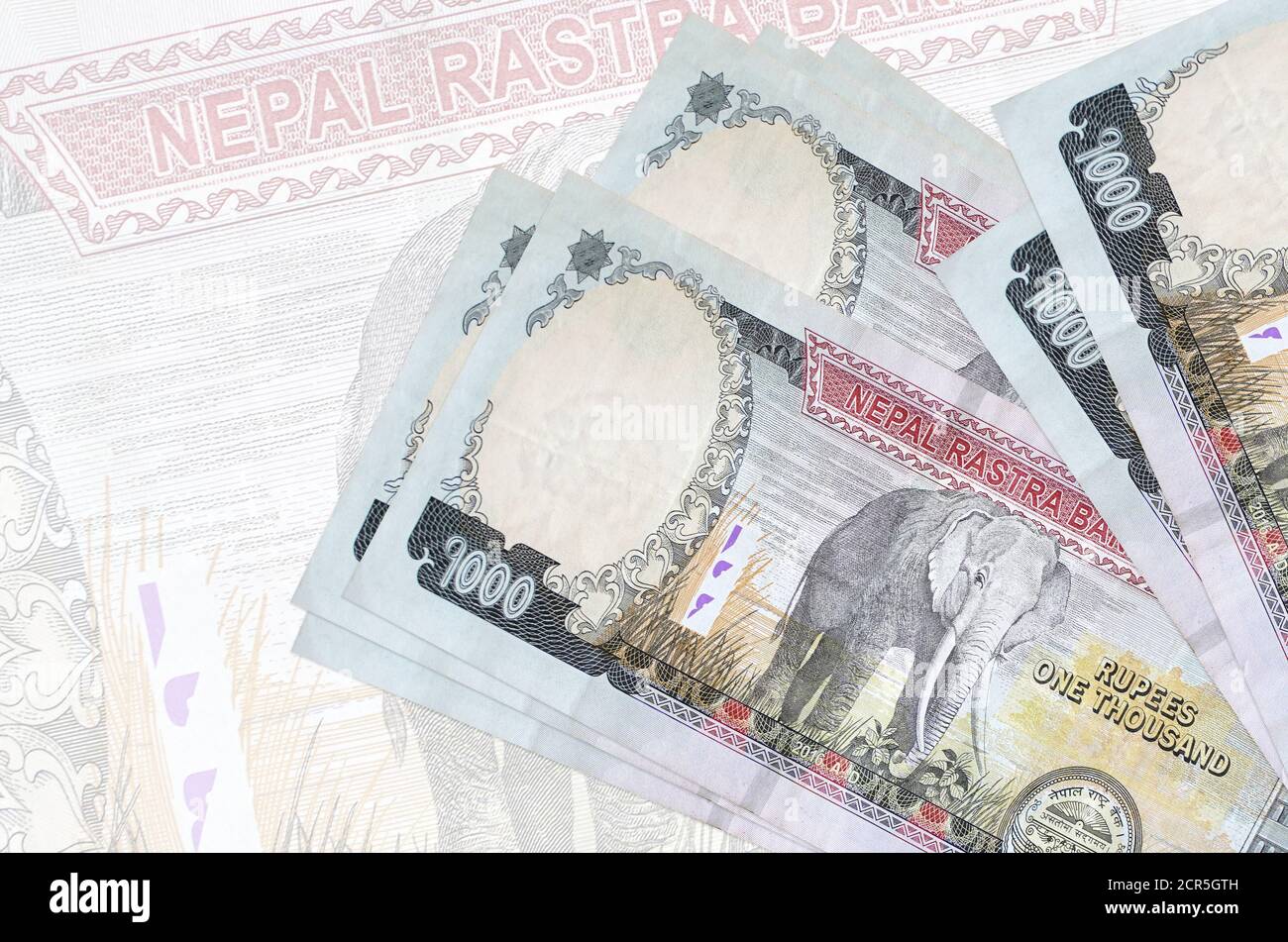 1000 Nepalese rupees bills lies in stack on background of big semi ...