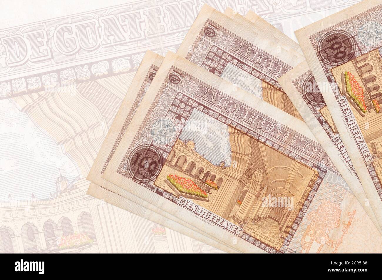 100 Guatemalan quetzales bills lies in stack on background of big semi ...
