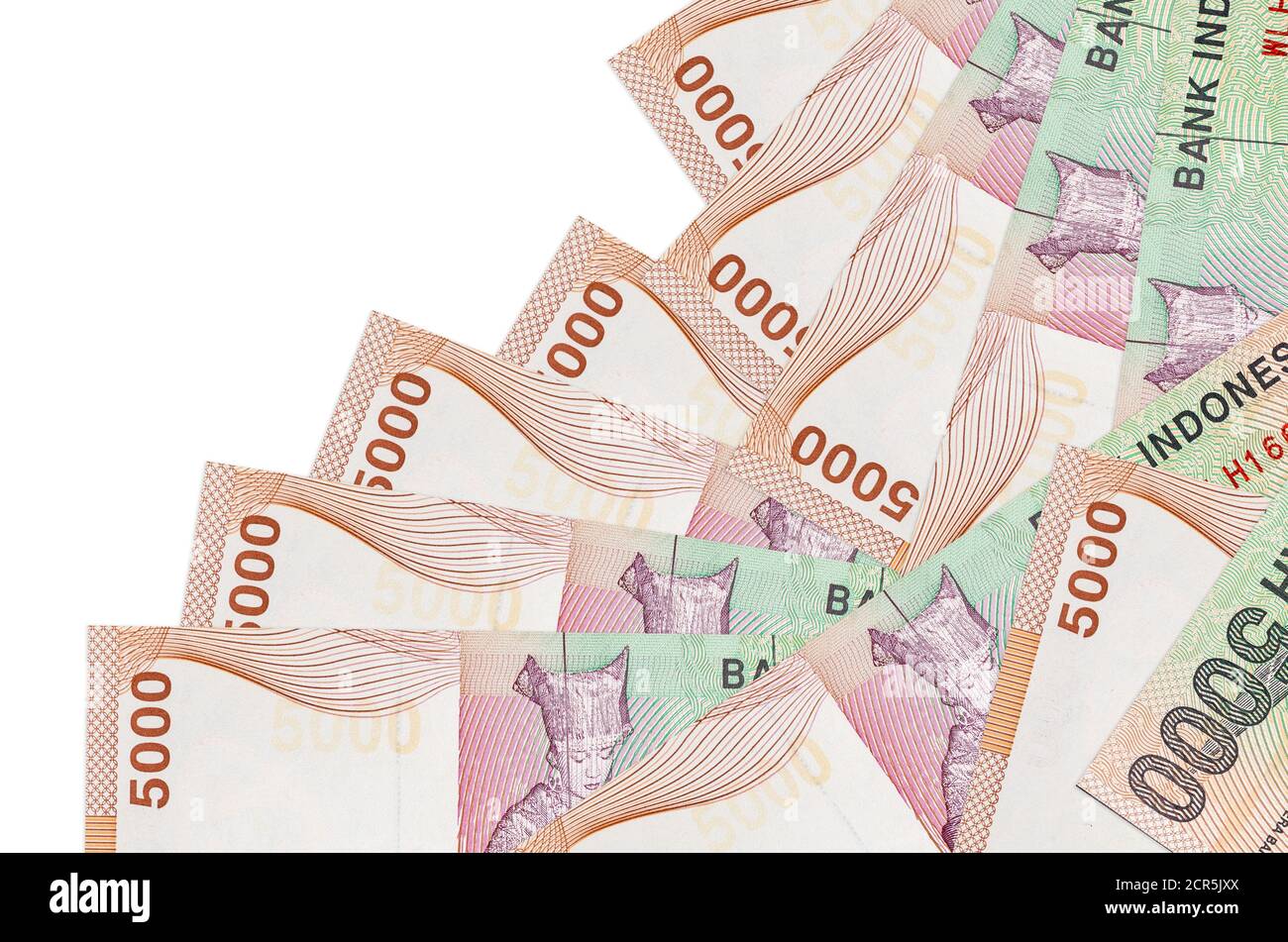 5000 Indonesian rupiah bills lies in different order isolated on white ...