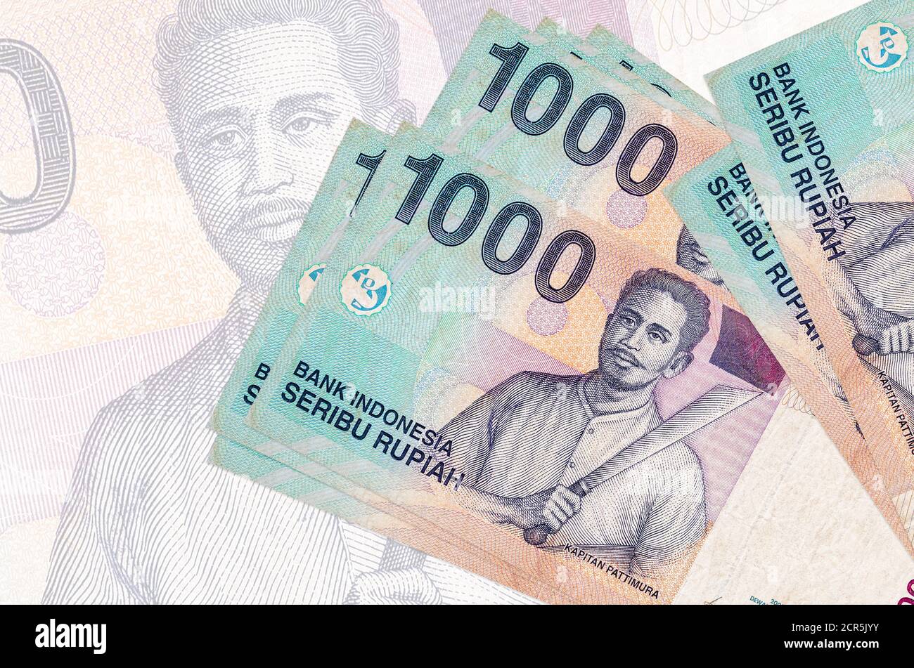 1000 Indonesian rupiah bills lies in stack on background of big semi ...