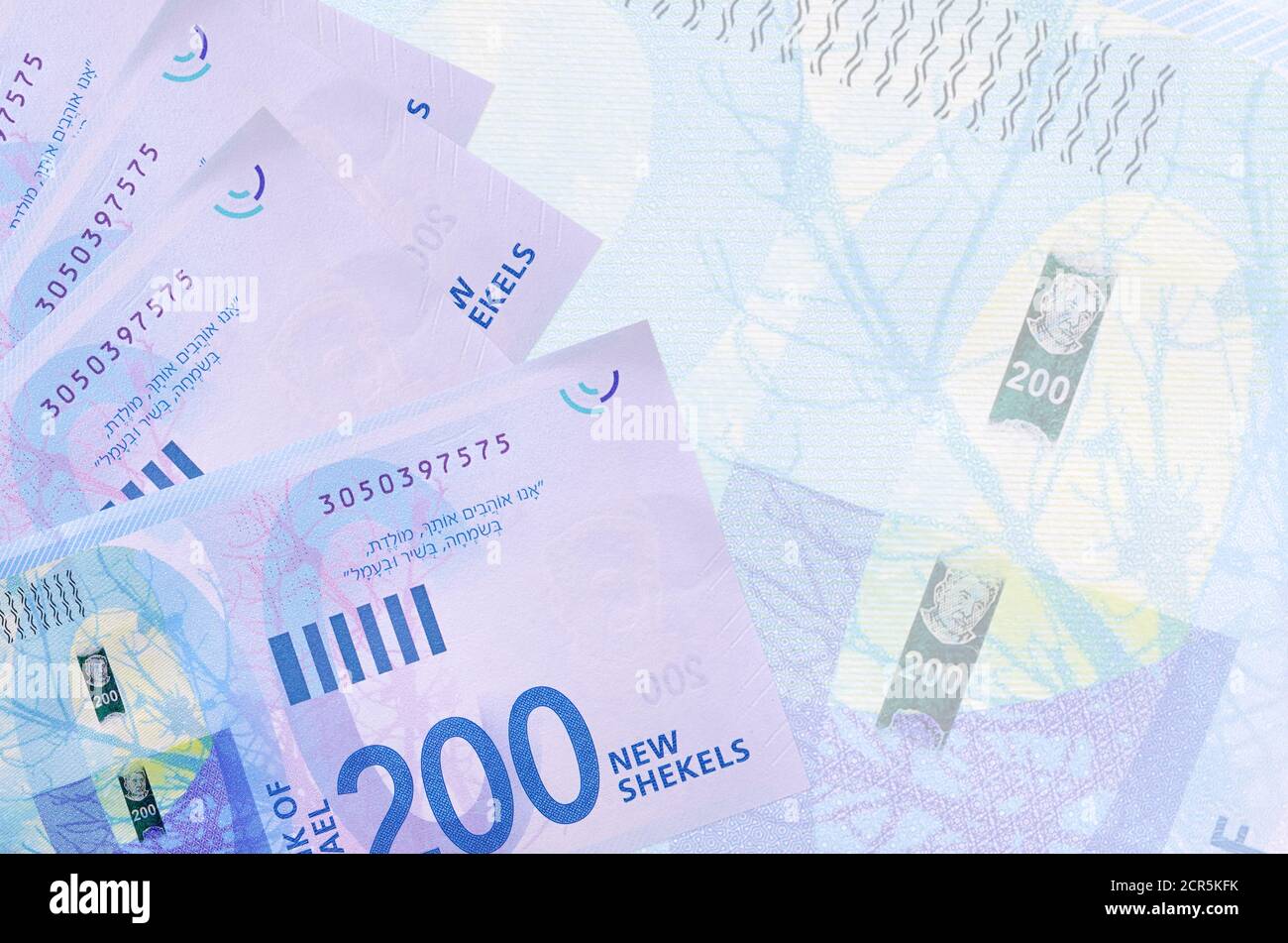 200 Israeli new shekels bills lies in stack on background of big semi ...