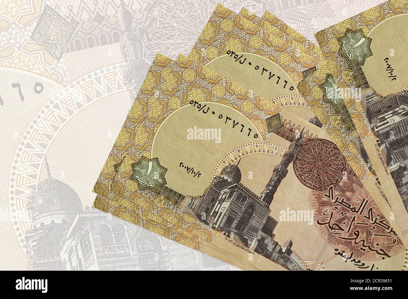 1 Egyptian pound bills lies in stack on background of big semi ...
