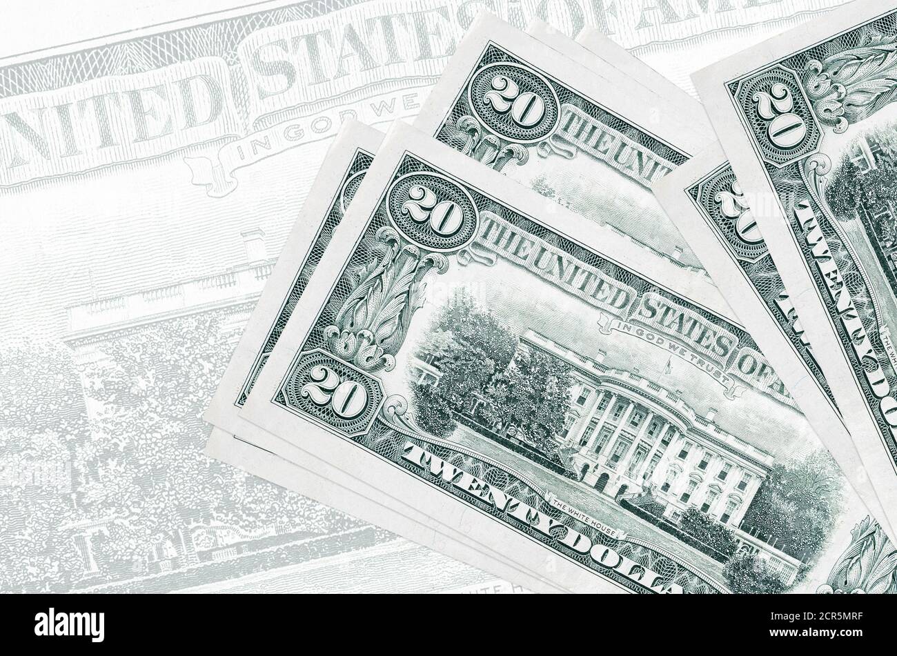 20 US dollars bills lies in stack on background of big semi-transparent ...