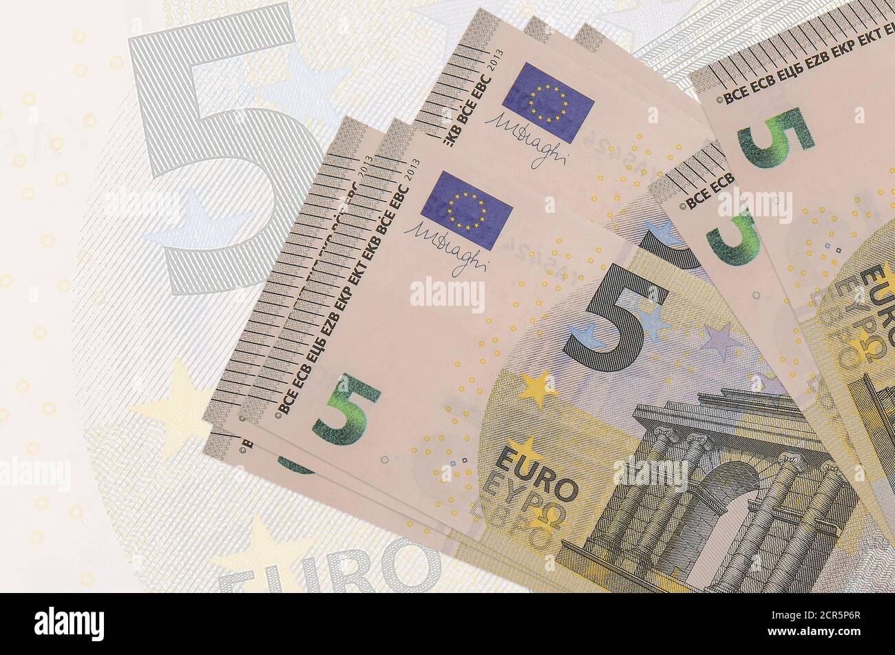 5 euro bills lies in stack on background of big semi-transparent ...