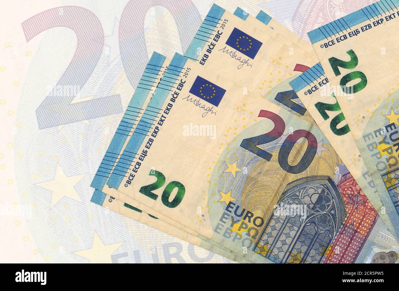 20 euro bills lies in stack on background of big semi-transparent ...