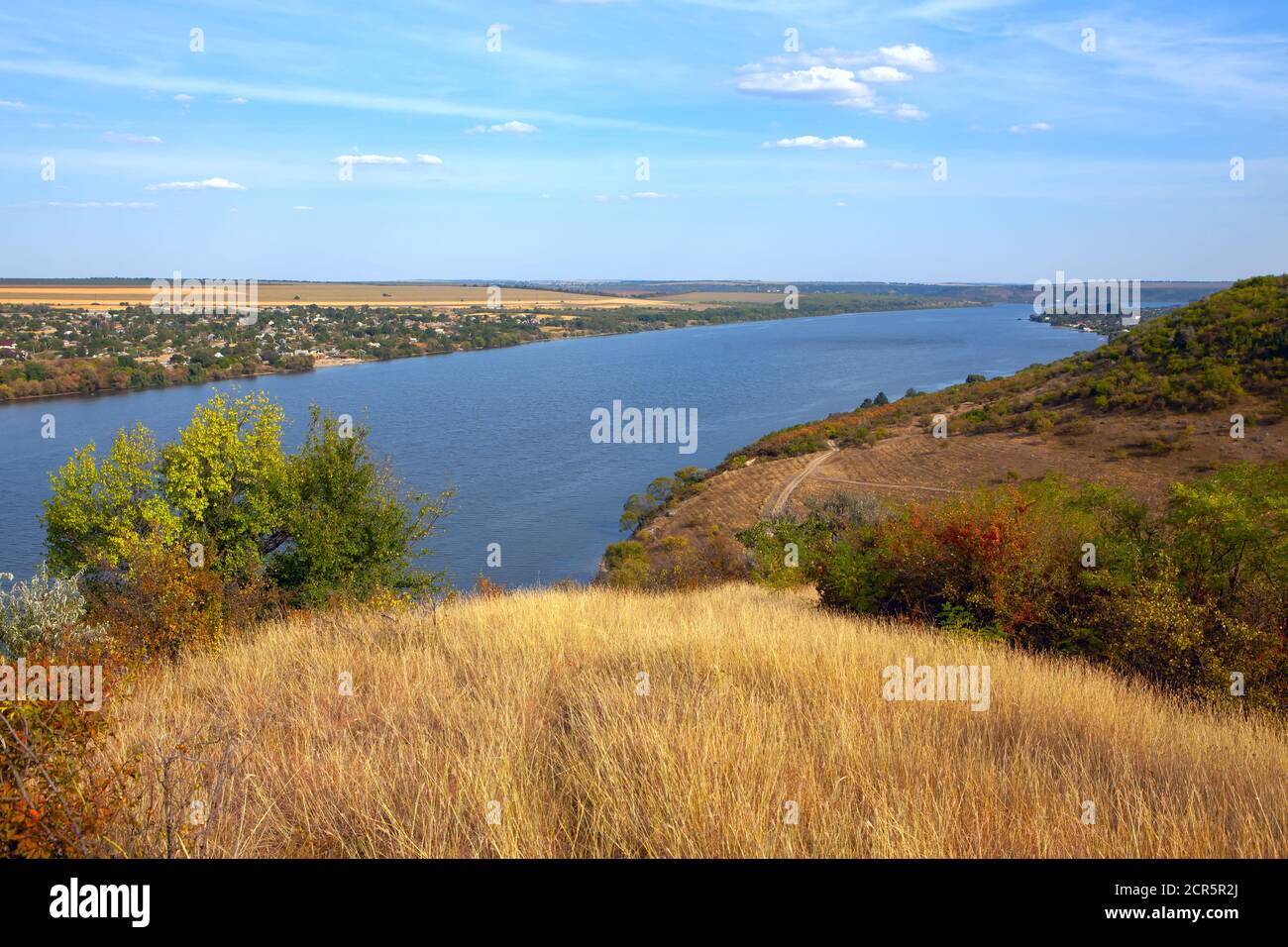 Rustic river scenery with village on the shore Stock Photo - Alamy