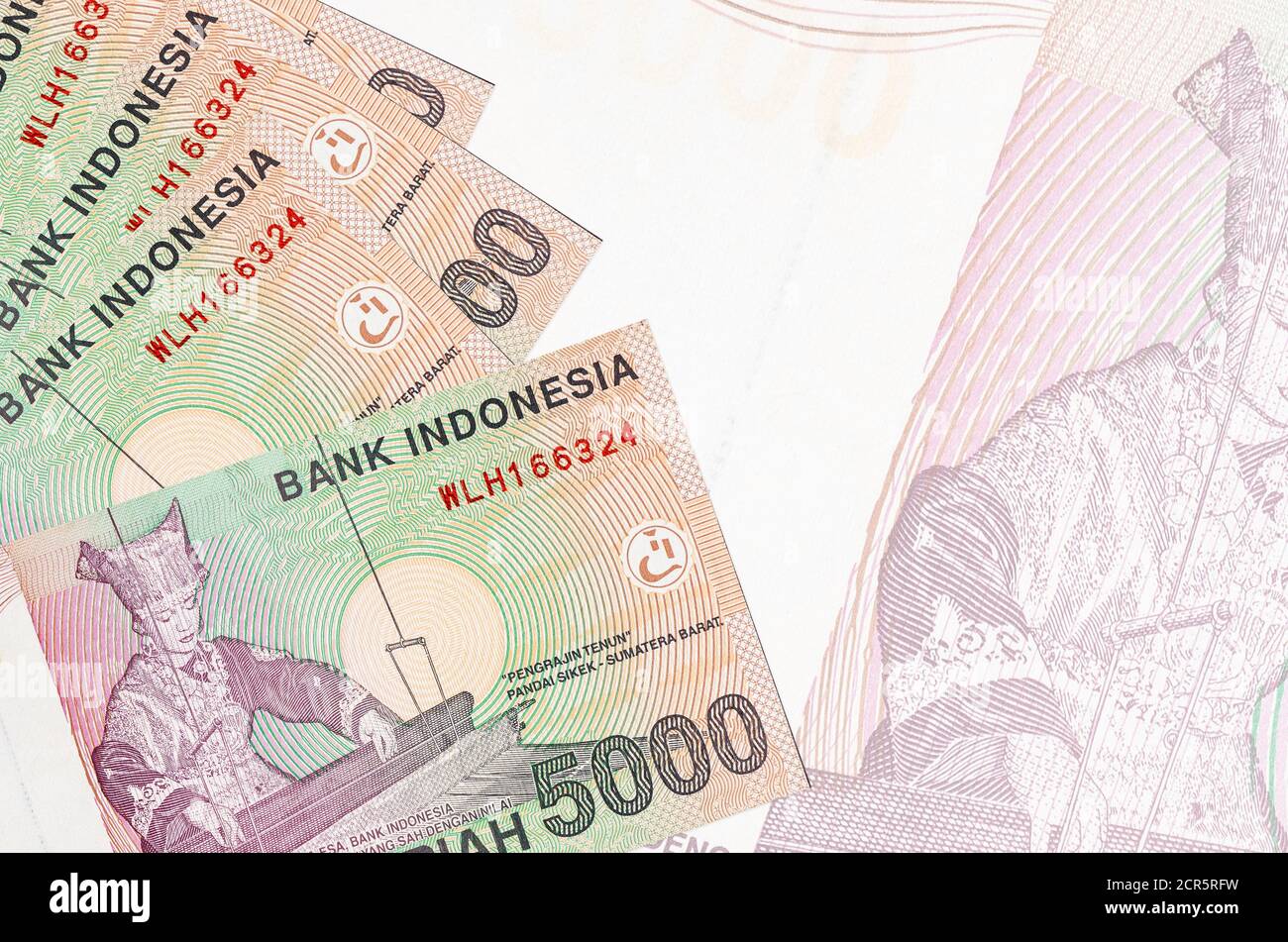 5000 Indonesian rupiah bills lies in stack on background of big semi ...