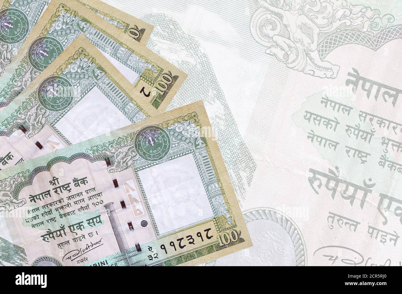 100 Nepalese rupees bills lies in stack on background of big semi ...