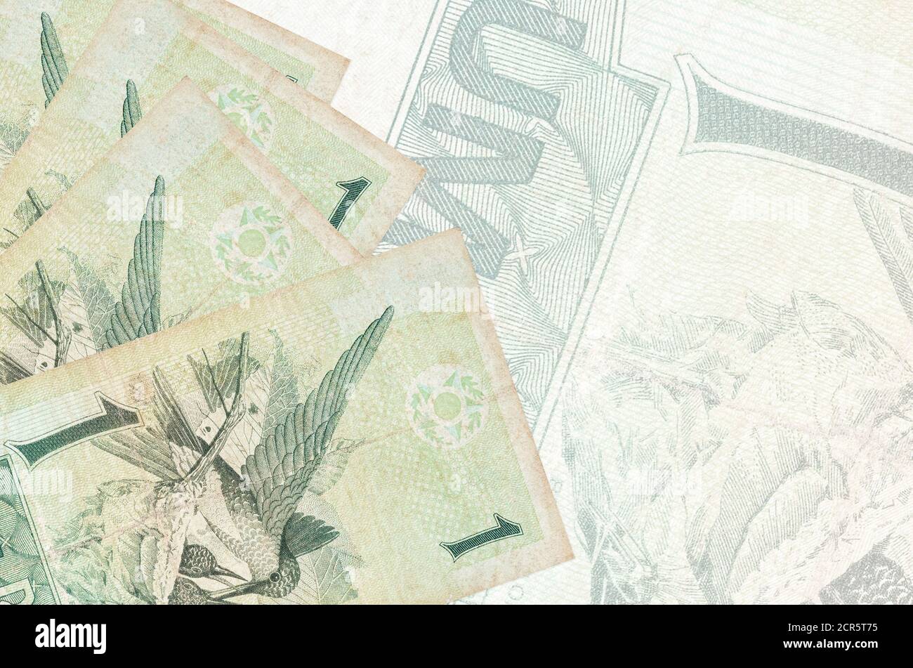 1 Brazilian real bills lies in stack on background of big semi ...