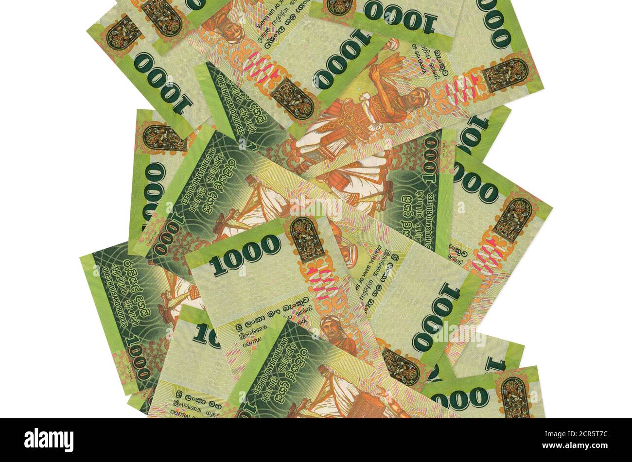 1000 Sri Lankan rupees bills flying down isolated on white. Many ...