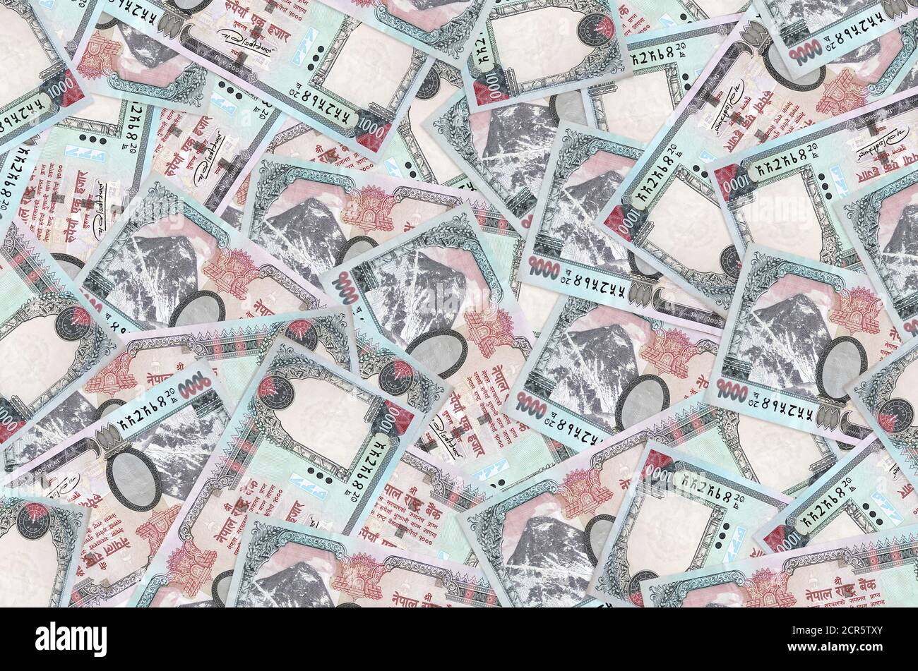 1000 Nepalese rupees bills lies in big pile. Rich life conceptual ...