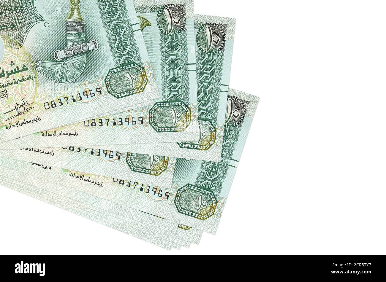 10 UAE dirhams bills lies in small bunch or pack isolated on white ...