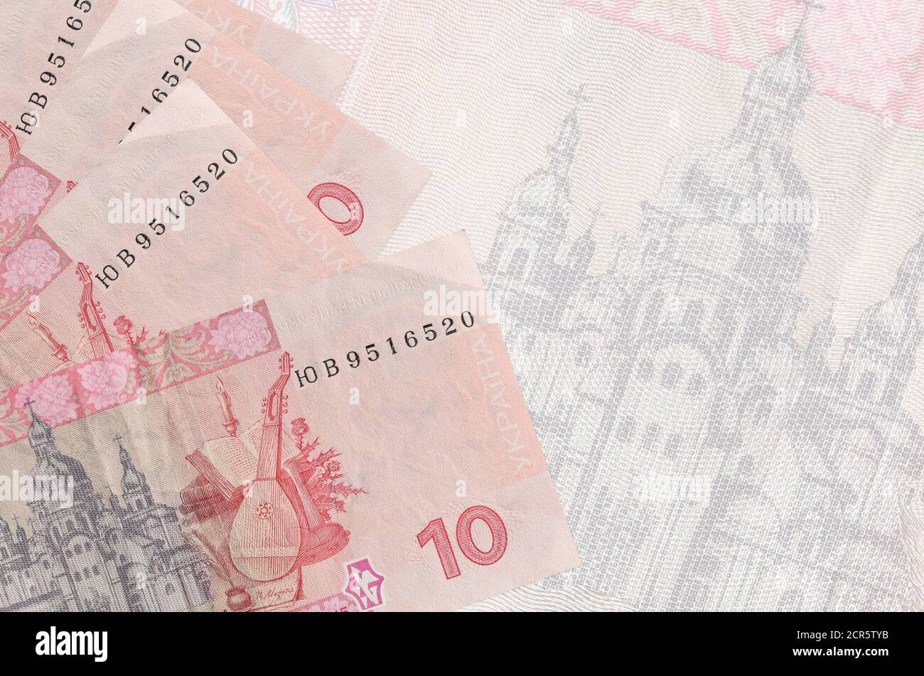 10 Ukrainian hryvnias bills lies in stack on background of big semi ...