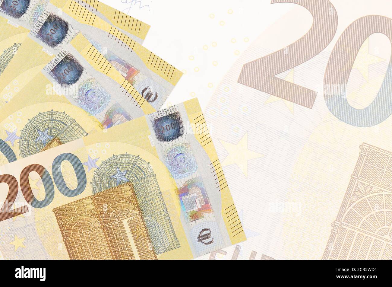200 euro bills lies in stack on background of big semi-transparent ...