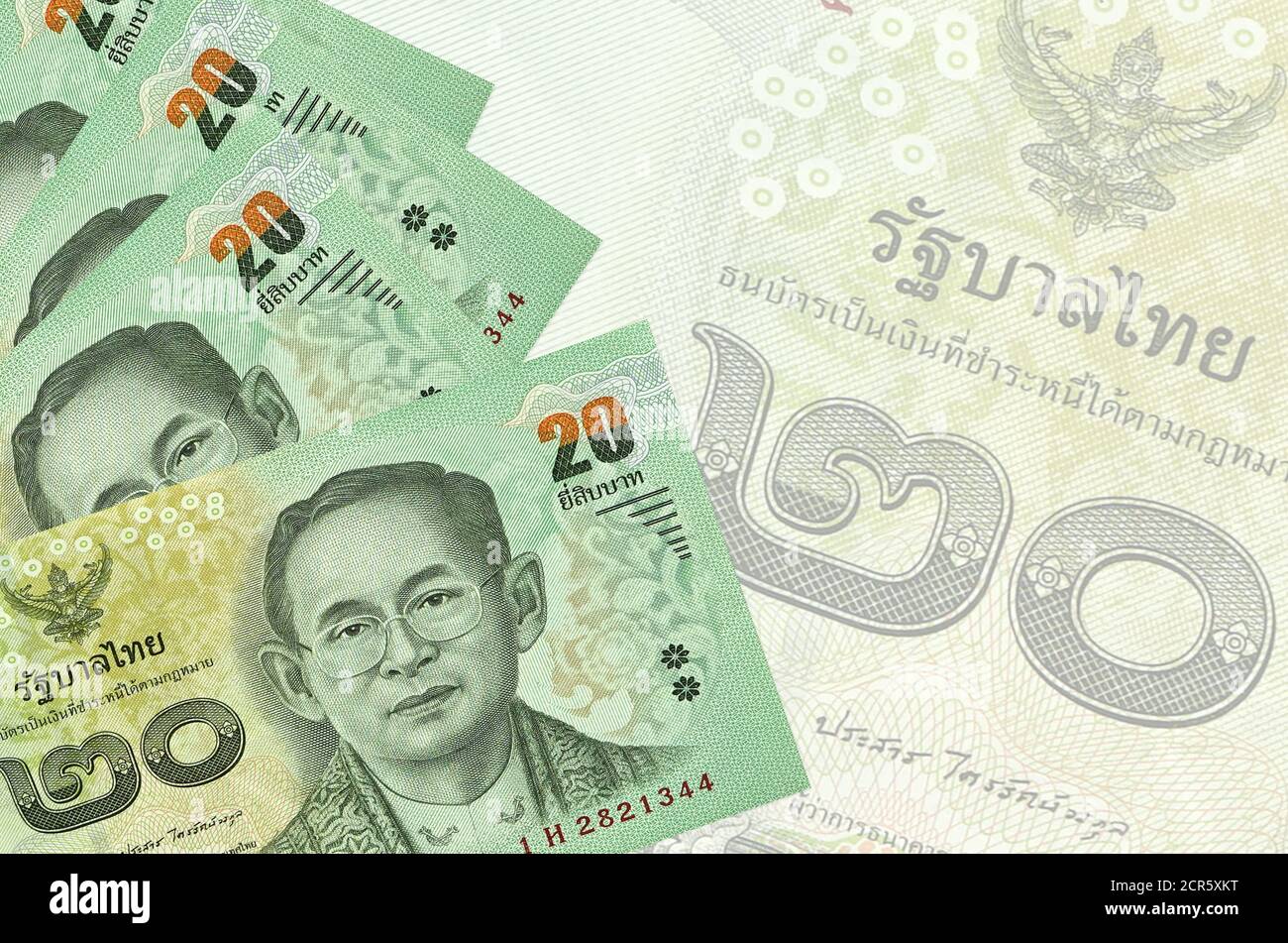 20 Thai Baht bills lies in stack on background of big semi-transparent ...
