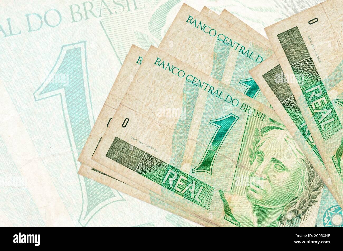 1 Brazilian real bills lies in stack on background of big semi ...