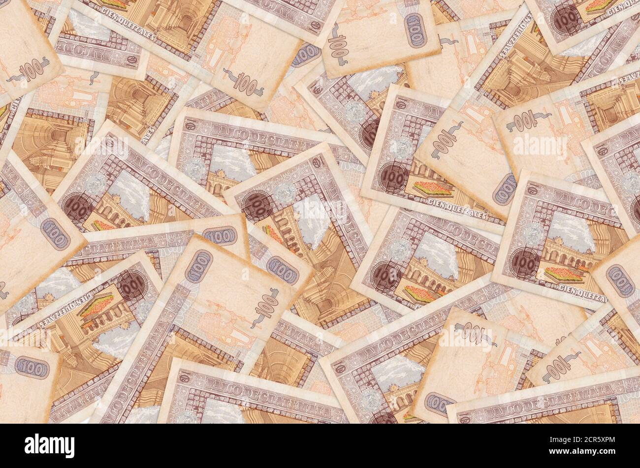 100 Guatemalan quetzales bills lies in big pile. Rich life conceptual ...