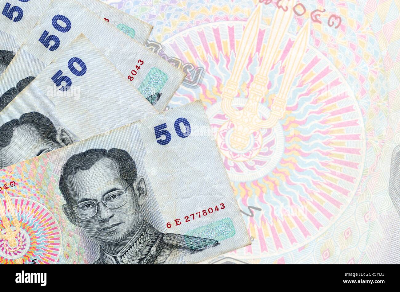 50 Thai Baht bills lies in stack on background of big semi-transparent ...