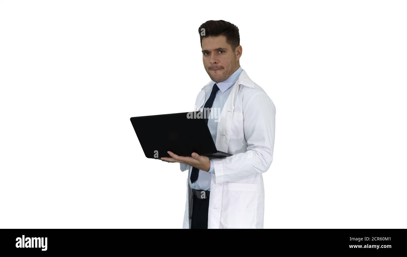 Cheerfull doctor with laptop laughing after giving a serious look to ...