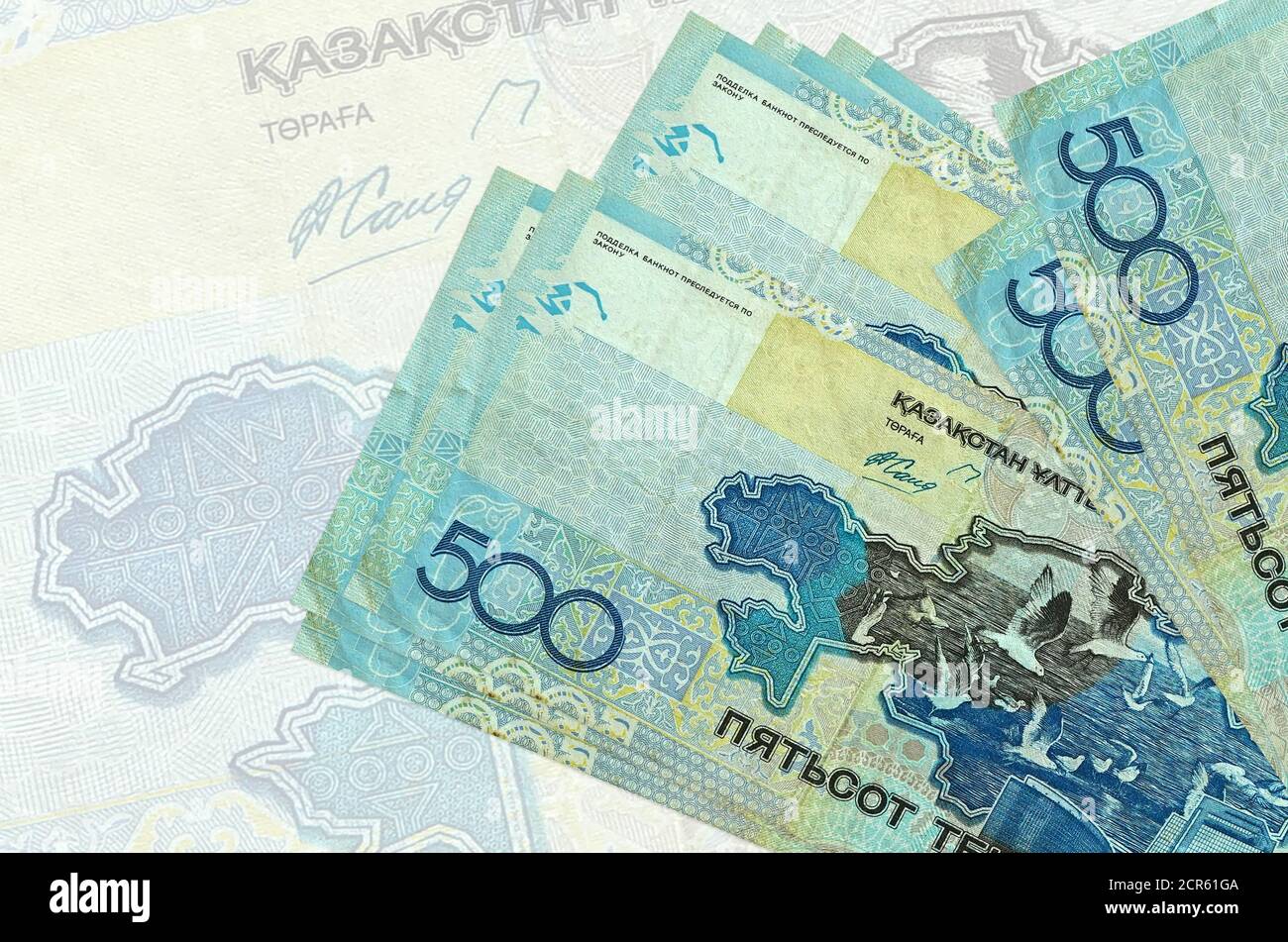500 Kazakhstani tenge bills lies in stack on background of big semi ...