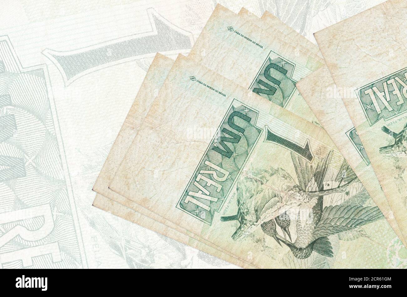 1 Brazilian real bills lies in stack on background of big semi ...