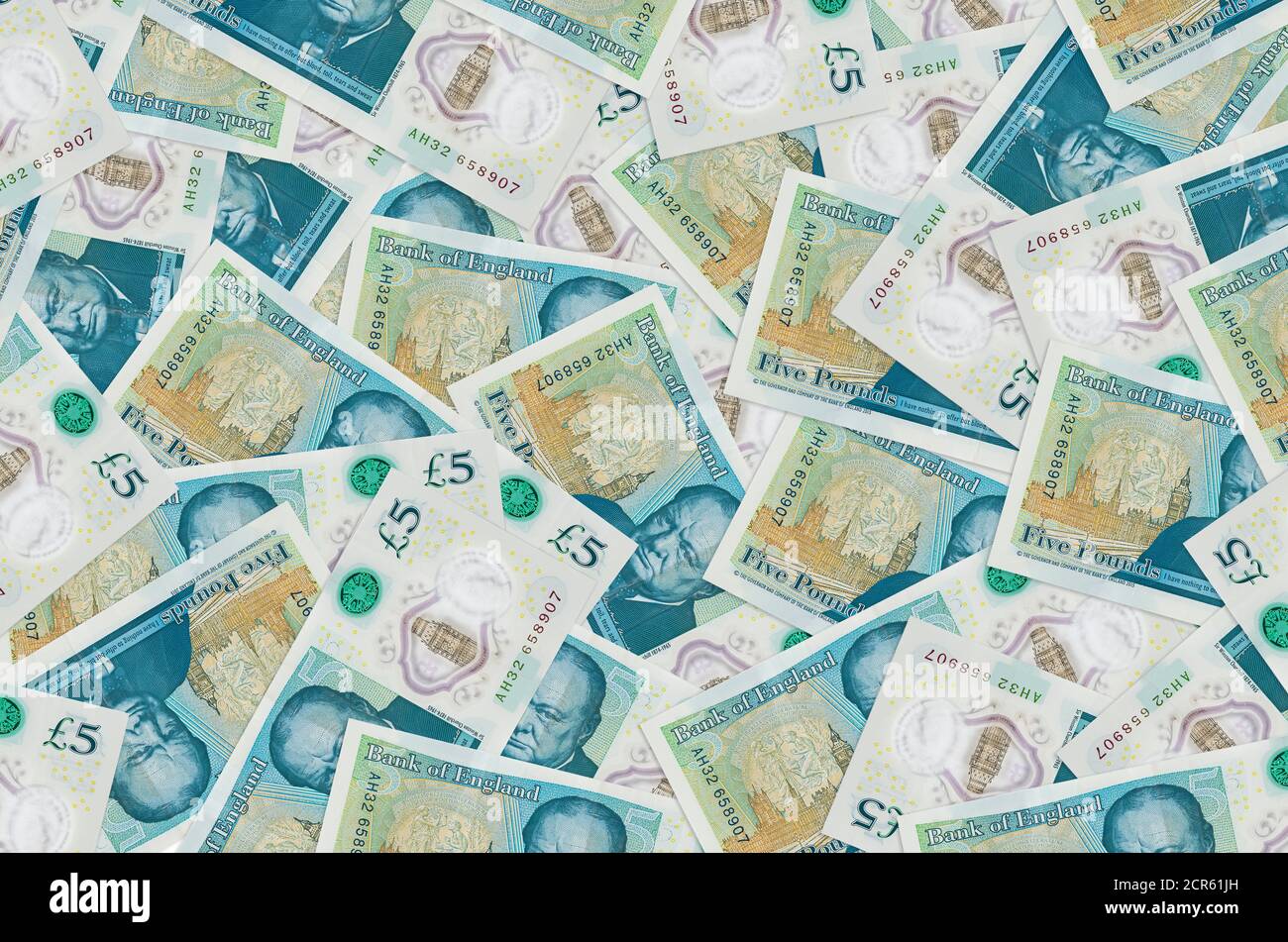 5 British pounds bills lies in big pile. Rich life conceptual ...