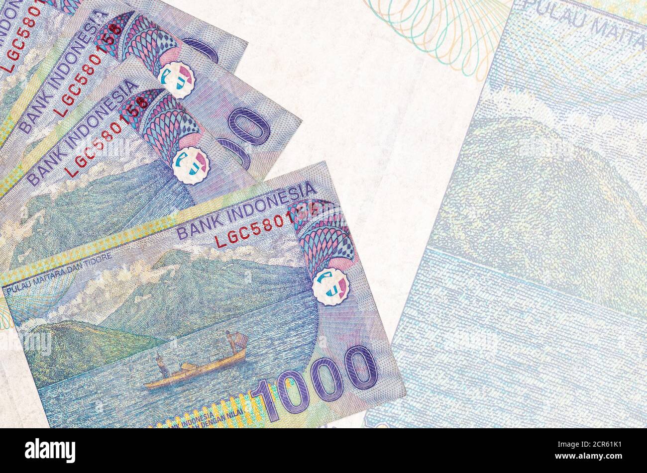 1000 Indonesian rupiah bills lies in stack on background of big semi ...