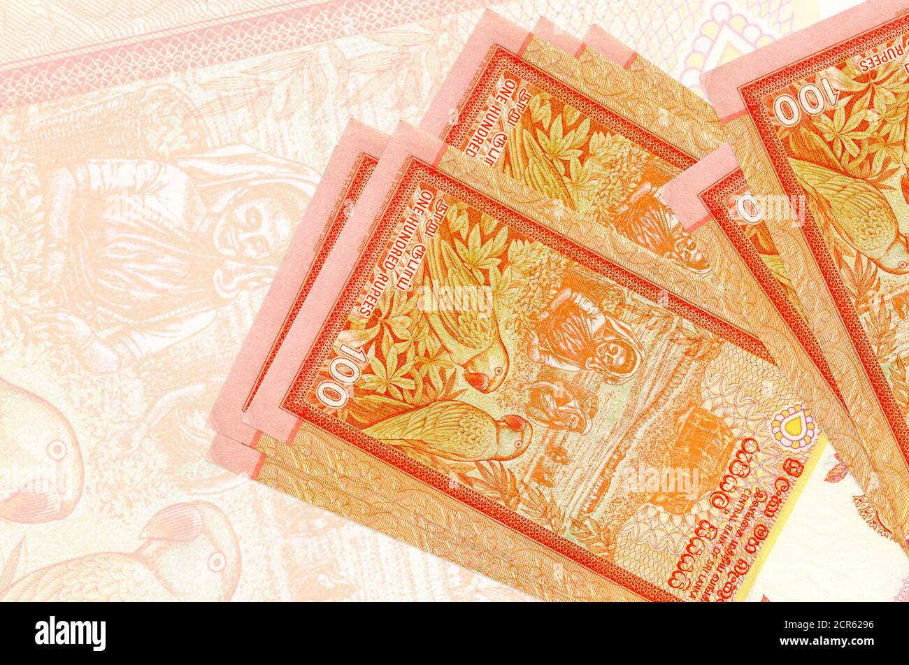 100 Sri Lankan rupees bills lies in stack on background of big semi ...