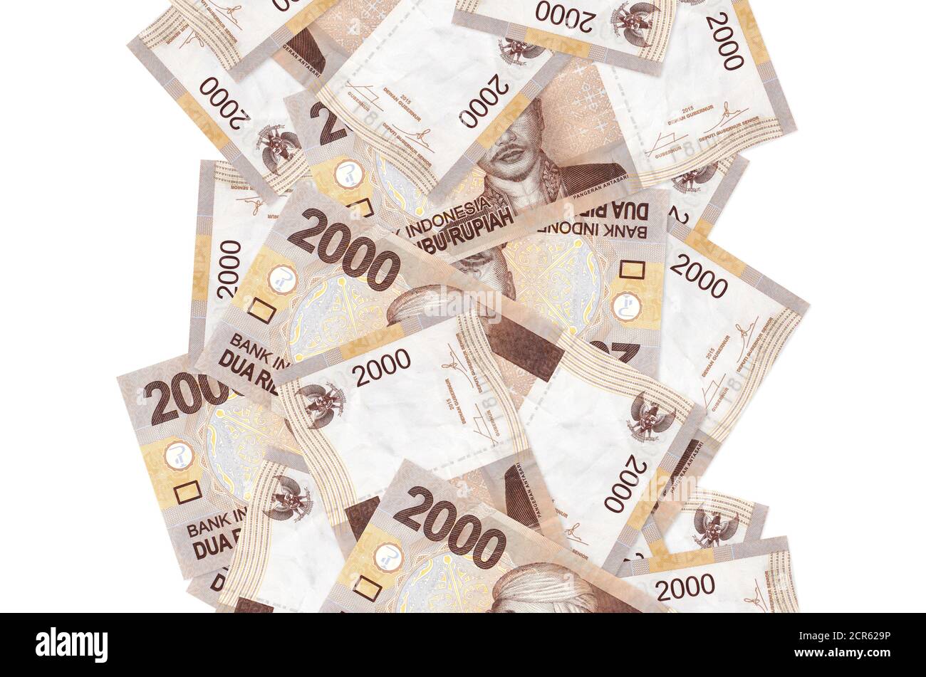 2000 Indonesian rupiah bills flying down isolated on white. Many ...