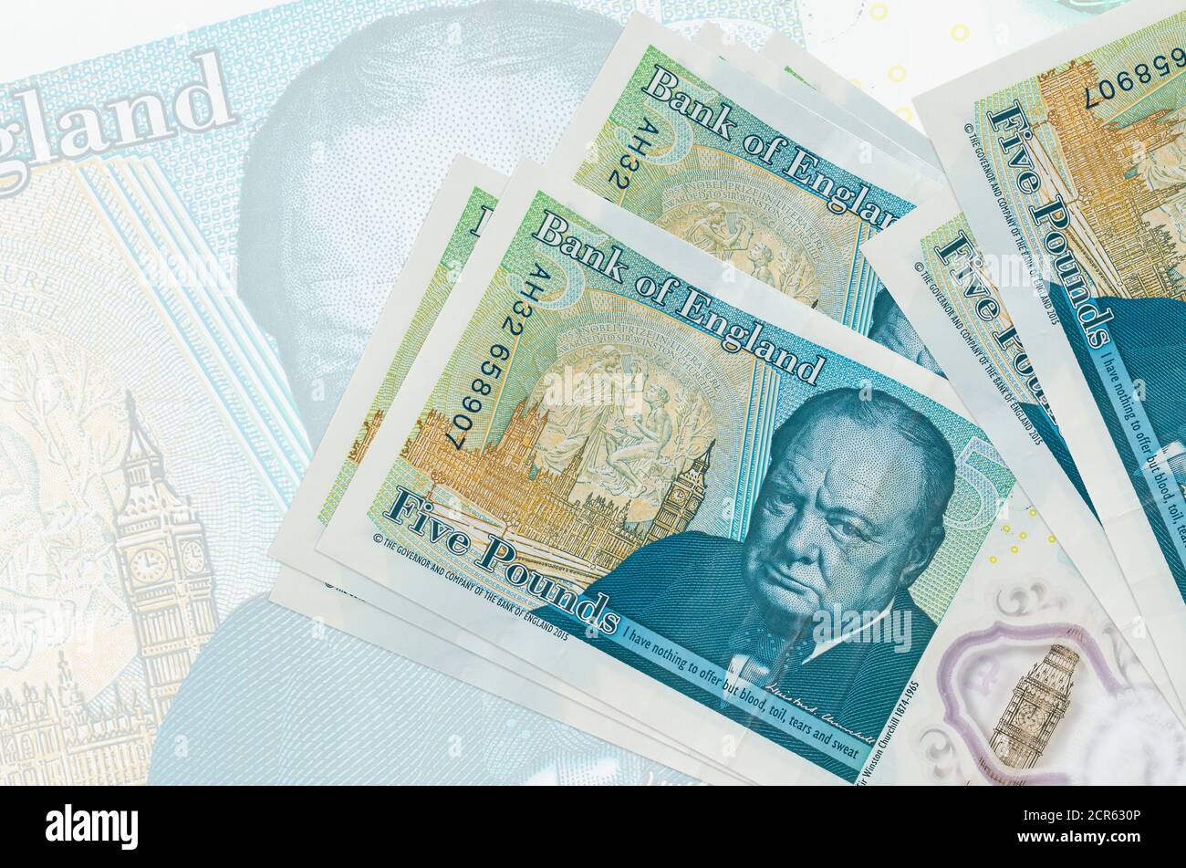 5 British pounds bills lies in stack on background of big semi ...