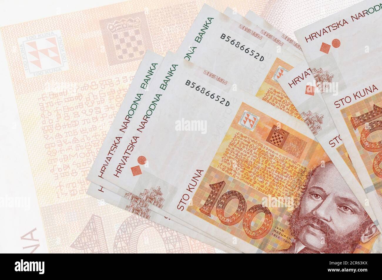 100 Croatian Kuna Bills Lies In Stack On Background Of Big Semi 100 Croatian Kuna Bills Lies In Stack On Background Of Big Semi