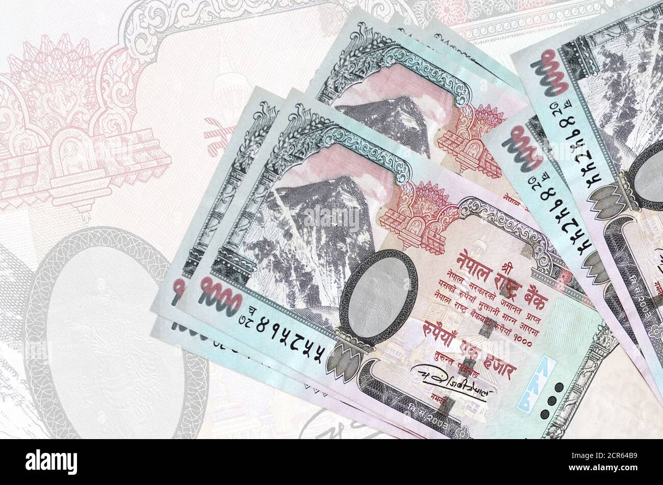 1000 Nepalese rupees bills lies in stack on background of big semi ...