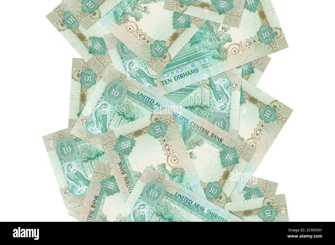 10 UAE dirhams bills flying down isolated on white. Many banknotes ...