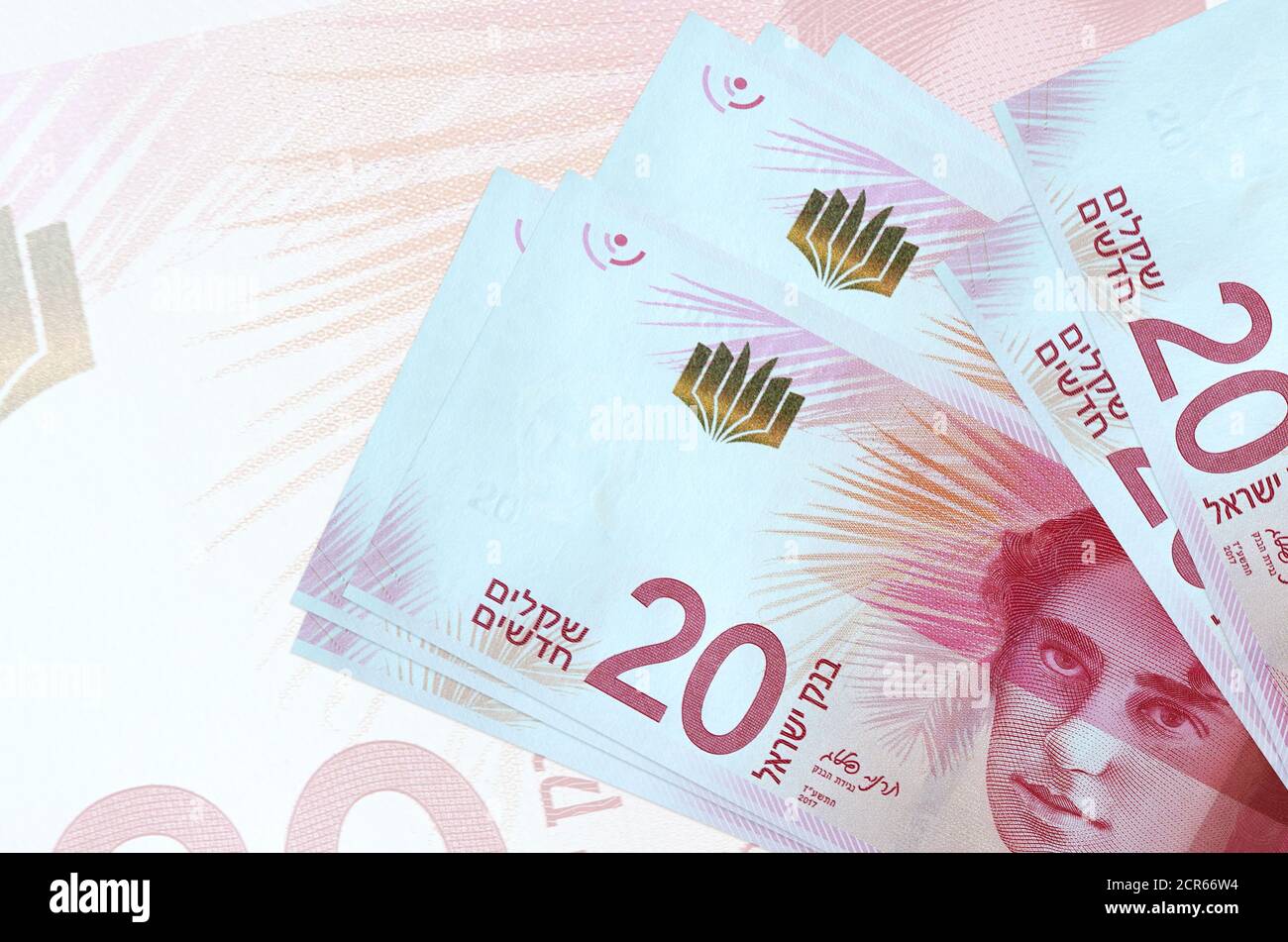 20 Israeli new shekels bills lies in stack on background of big semi ...