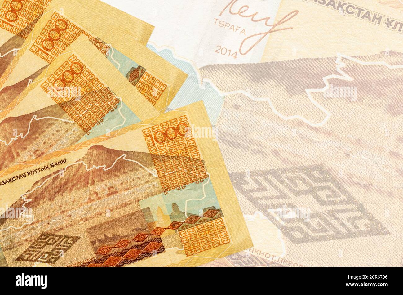 1000 Kazakhstani tenge bills lies in stack on background of big semi ...