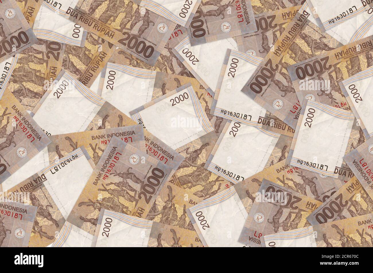 2000 Indonesian rupiah bills lies in big pile. Rich life conceptual ...