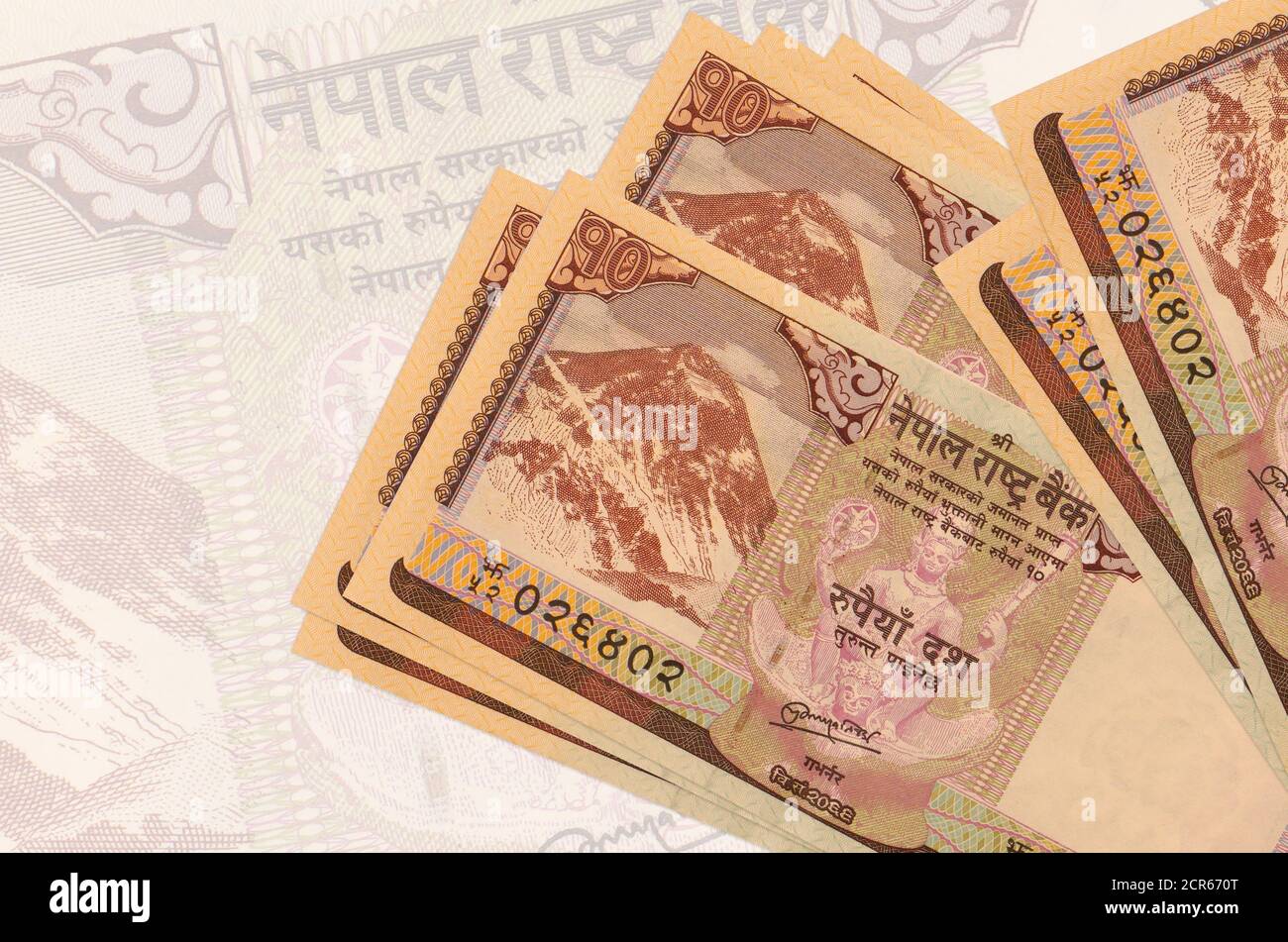 10 Nepalese rupees bills lies in stack on background of big semi ...