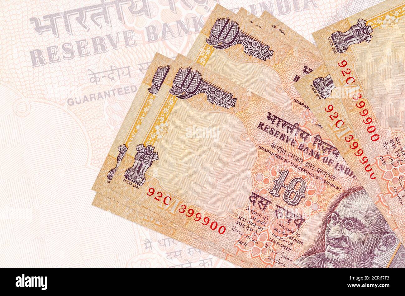 10 Indian rupees bills lies in stack on background of big semi ...