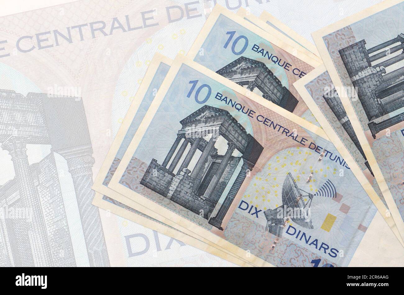 10 Tunisian dinars bills lies in stack on background of big semi ...