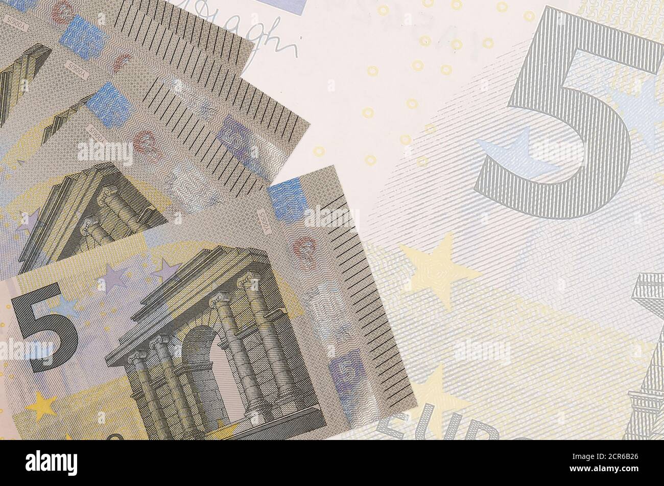 5 euro bills lies in stack on background of big semi-transparent ...