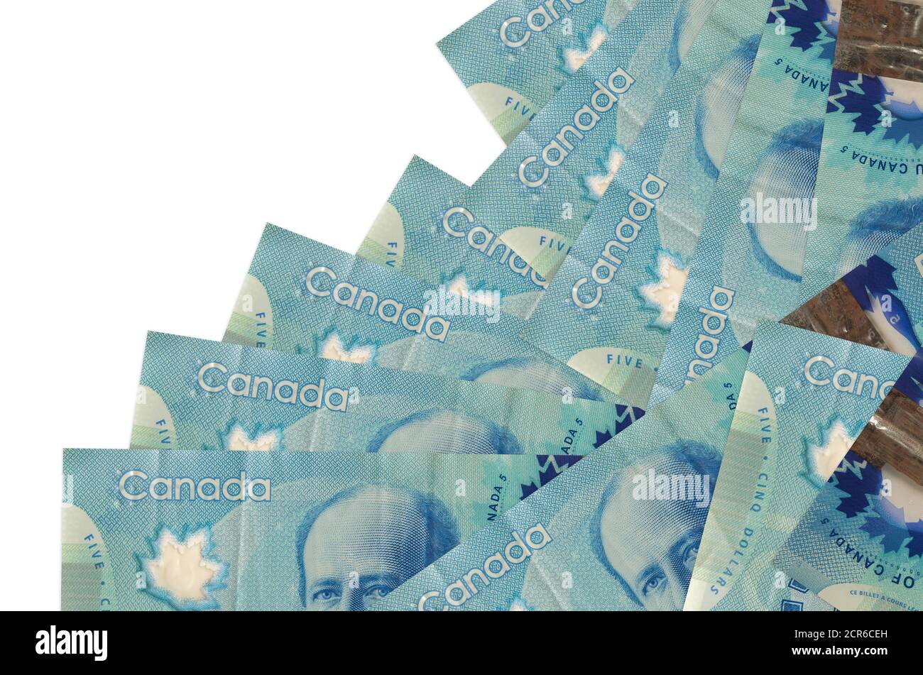 5 Canadian dollars bills lies in different order isolated on white ...