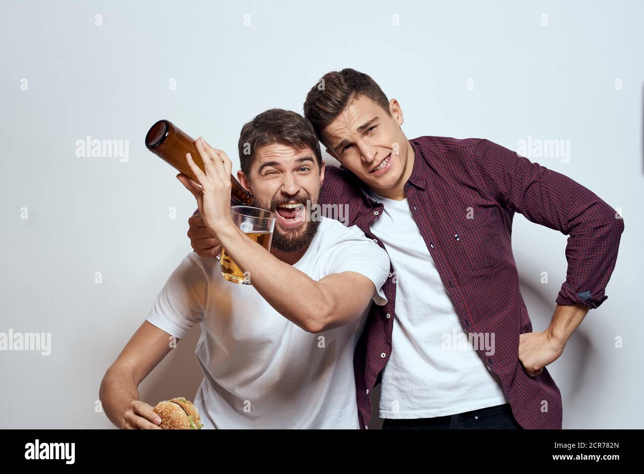 Two cheerful friends drinking beer drunk fun lifestyle communication ...