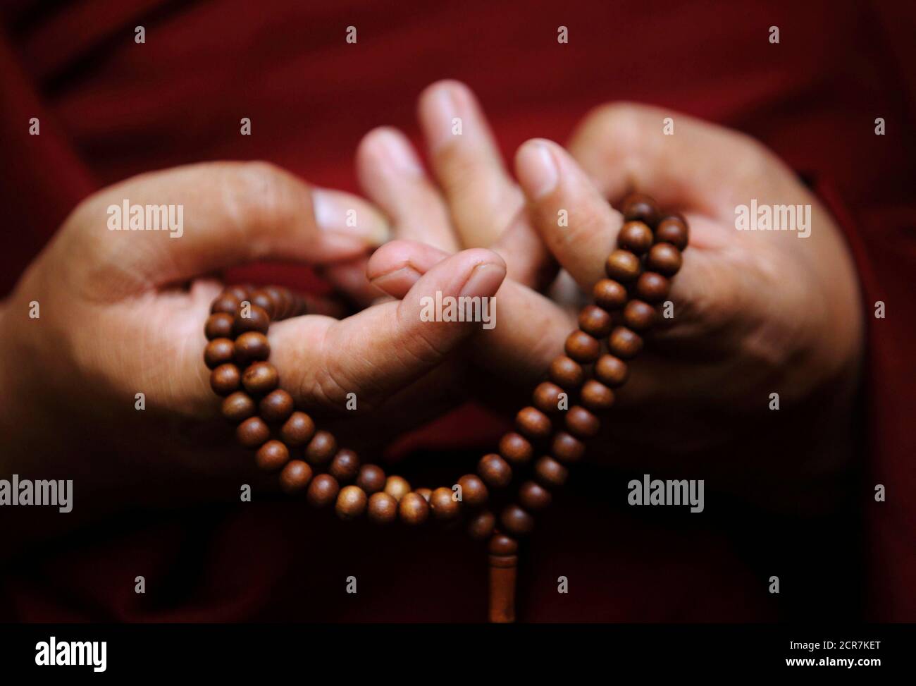 Tibetan buddhist monk praying beads hi-res stock photography and images ...