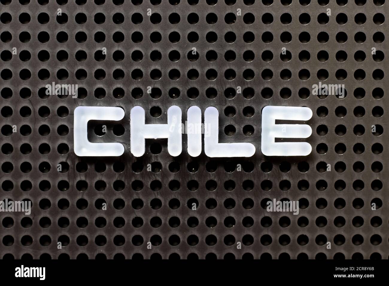 White color alphabet with word chile on black pegboard background Stock ...